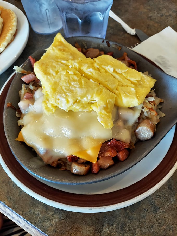 Hash browns meeting cheese and eggs under fluffy omelette blankets—this is how mornings are supposed to start.