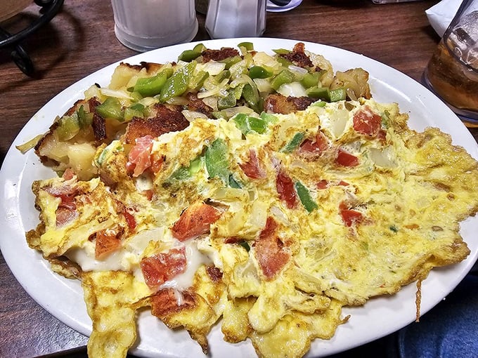 This omelet doesn't just contain vegetables—it showcases them. Those home fries look like they've earned a PhD in crispiness.