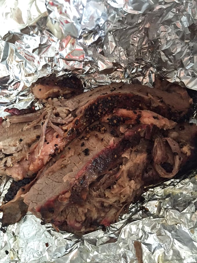 Behold the holy grail of barbecue – brisket with that perfect pink smoke ring. This isn't just meat; it's a time-honored tradition wrapped in aluminum foil.