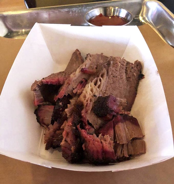 Behold the star of the show: brisket with that coveted pink smoke ring and bark so perfect it deserves its own Instagram account.