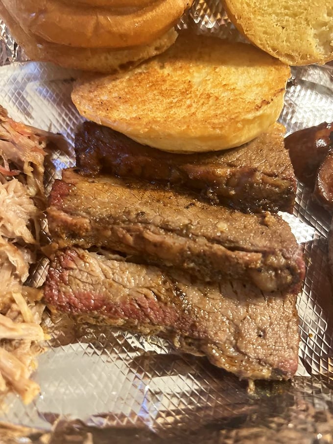 Behold the brisket – with that perfect smoke ring and bark that would make tree trunks jealous. This isn't food; it's edible poetry.