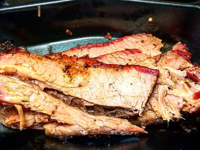 Behold the brisket in all its glory – that pink smoke ring isn't just for show, it's a badge of honor earned through hours of patient smoking.