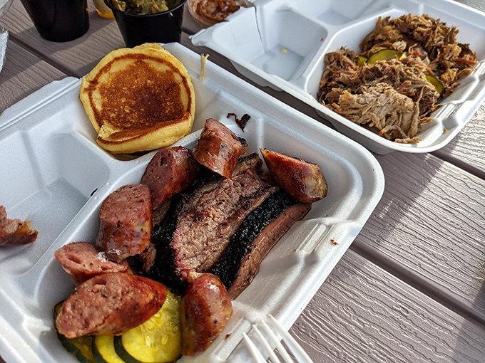 Meat candy in its natural habitat. That smoke ring on the brisket is the BBQ equivalent of a Rolex – a sign of true craftsmanship.