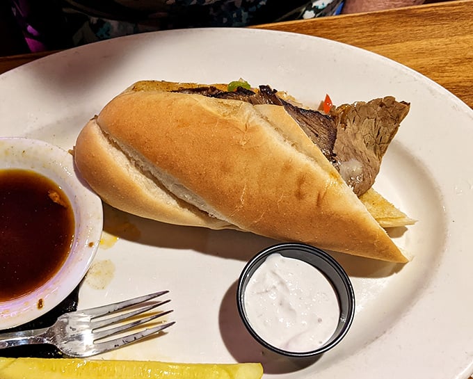 The prime rib sandwich arrives with its own bodyguards—au jus and horseradish cream. This is sandwich diplomacy at its finest.