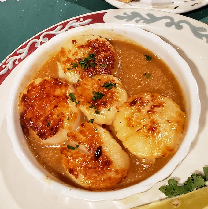 These broiled scallops aren't just swimming in butter sauce—they're doing the backstroke in flavor heaven, waving at you to join them.
