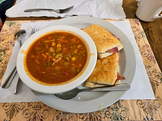 Brunswick stew that looks like it could heal whatever ails you—chunky, rustic, and served with a sandwich that's clearly not an afterthought.