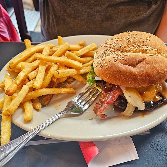This isn't just a burger—it's edible architecture. Notice how the melty cheese cascades perfectly over that sesame-speckled bun.