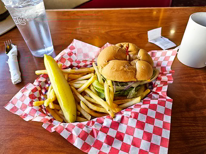 This burger doesn't just sit on the plate—it commands attention like a diva on opening night, with those golden fries playing a perfect supporting role.