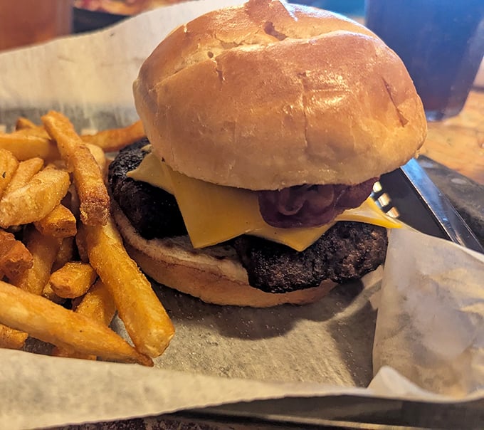 Behold, the burger of your dreams. This isn't fast food—it's slow food done right, with golden fries standing guard.