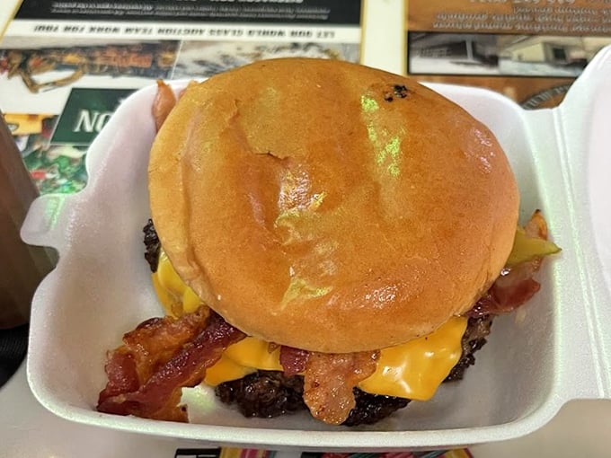 Behold the burger in all its glory—where melted cheese cascades over a perfectly seared patty, and bacon stands at attention like it's reporting for delicious duty.
