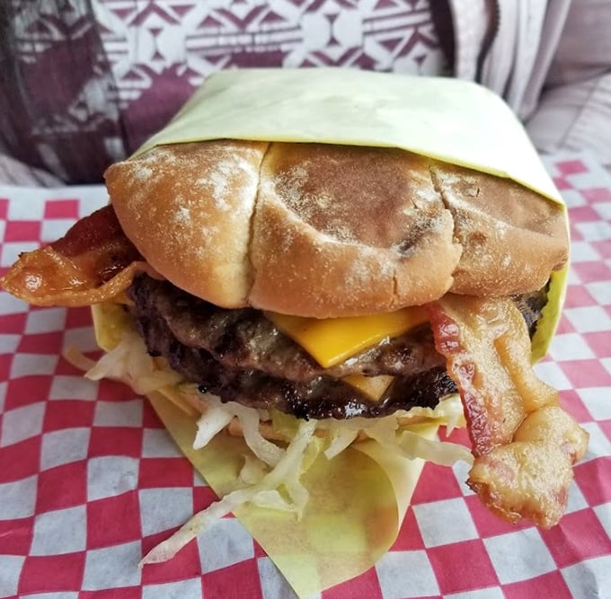 This isn't just a bacon cheeseburger; it's edible architecture where each layer plays its part in a symphony of flavors that makes calories irrelevant.