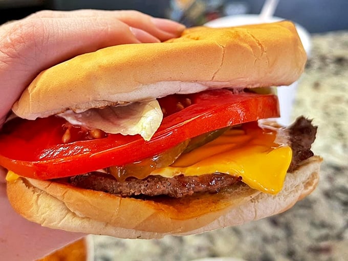 This isn't just a cheeseburger—it's edible architecture where each layer plays its part in a symphony of flavors that's been bringing smiles since Eisenhower.
