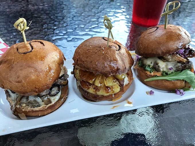 Three slider burgers standing at attention like tiny edible soldiers. The kind of food that makes you want to salute before devouring.