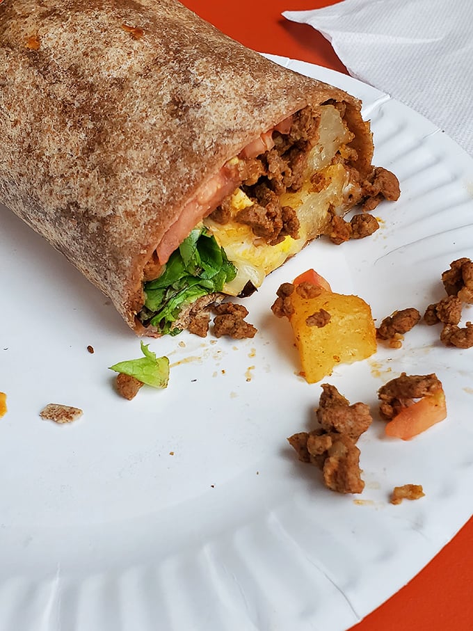 Behold the breakfast burrito in all its glory—where seasoned ground beef, eggs, and potatoes unite in tortilla-wrapped perfection.