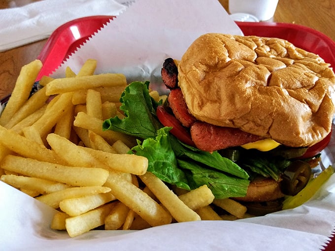 Behold the California Burger in its natural habitat—a red basket lined with paper, accompanied by fries that demand equal attention.
