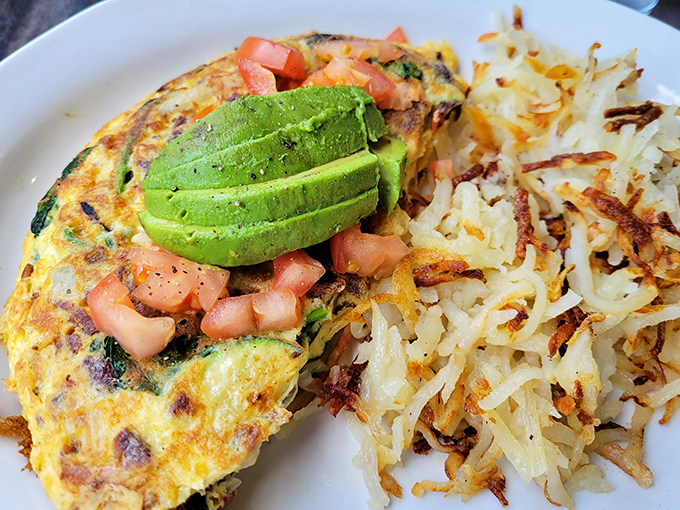 This California omelet doesn't just talk the talk—perfectly cooked eggs cradle fresh avocado and diced tomatoes alongside hash browns that achieve the golden-brown perfection we all attempt at home.