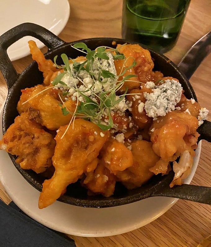 Buffalo cauliflower that makes you question everything you thought you knew about vegetables—crispy, saucy, and topped with blue cheese crumbles.