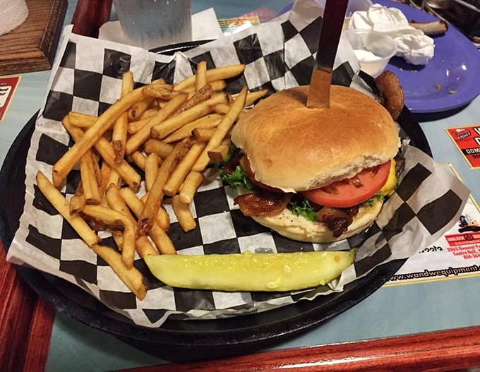 This isn't just a burger – it's architecture. The perfect stack of beef, cheese, and fresh veggies on a golden bun with crispy fries standing guard.