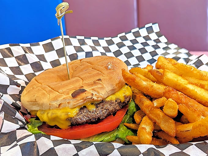This isn't just a cheeseburger; it's edible architecture – a hand-formed patty wearing its cheese like a melted crown, served with fries that demand to be dunked.