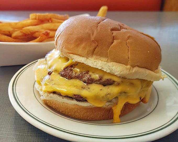 Melted cheese cascading down a perfectly grilled patty—this isn't just a cheeseburger, it's edible poetry on a plate.