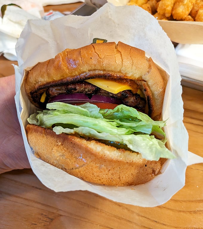 Not so much a burger as a hand-held celebration. Note the perfect char marks – the grill's autograph on a masterpiece.