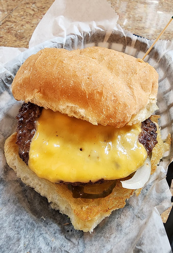 Behold the star of the show: a cheeseburger so perfectly melty and juicy, it should have its own fan club and merchandise line.