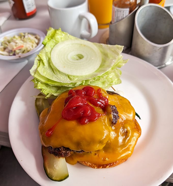 Behold the cheeseburger that launched a thousand return visits – melted perfection meets char-grilled excellence.