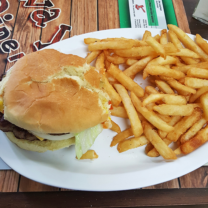 Behold the star attraction: a perfectly proportioned cheeseburger with golden fries that would make fast food chains weep with inadequacy.