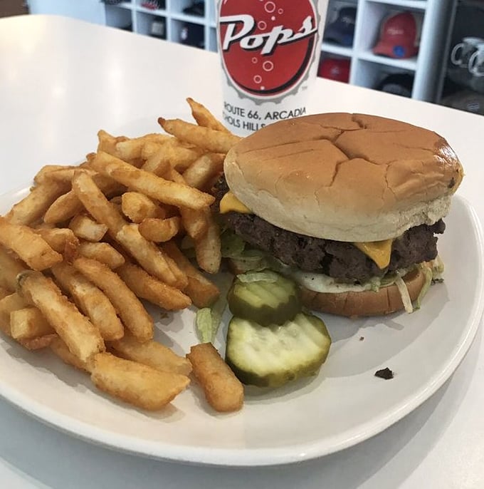 This isn't just a cheeseburger—it's edible Americana. Golden fries, crisp pickles, and a perfectly proportioned patty that makes drive-thru burgers weep with inadequacy.