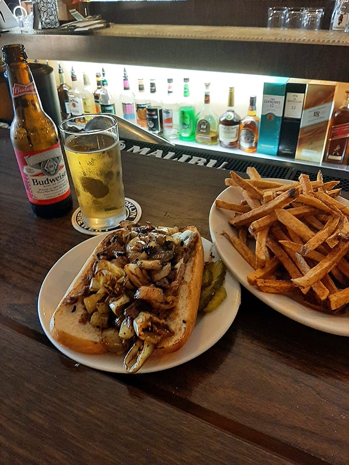Behold the star attraction—thinly sliced beef, caramelized onions, and melted cheese creating the holy trinity of sandwich perfection.