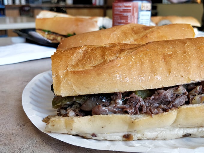 Behold the star of the show – thinly sliced beef nestled in a perfect roll with melted cheese and peppers. Poetry you can eat.