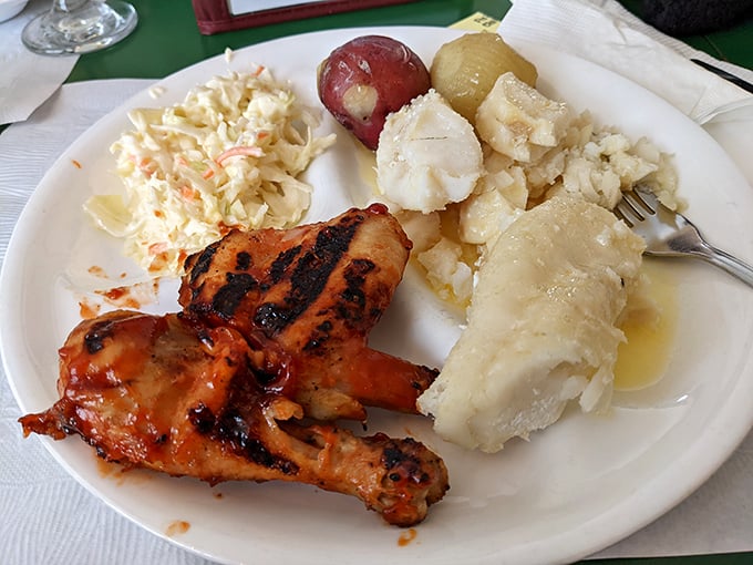 Golden-brown chicken that makes a satisfying crunch heard 'round the table, served with creamy coleslaw and potatoes that could make a carb-counter weep with joy.