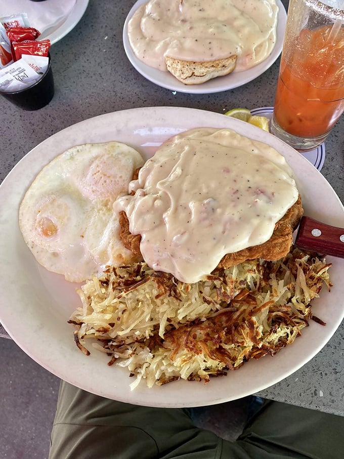 Behold the holy grail—Cappy's chicken fried steak smothered in peppery country gravy with crispy hash browns and eggs. This plate doesn't just satisfy hunger; it conquers it.