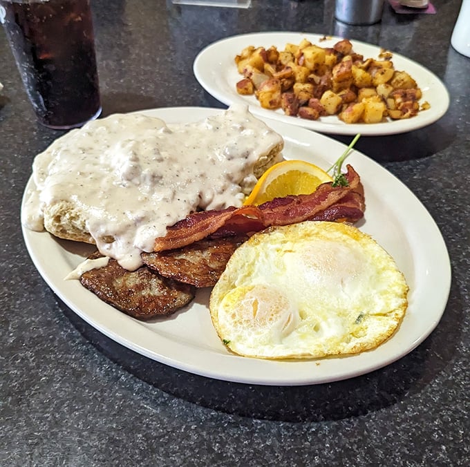 Behold the holy trinity of diner perfection: creamy gravy cascading over crispy chicken fried steak, with eggs and potatoes standing by for backup.