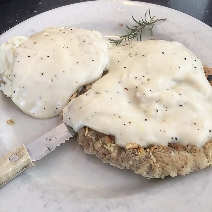 Behold the holy grail of Texas cuisine—chicken fried steak bathed in peppery cream gravy that's so good it might make you question your life choices.