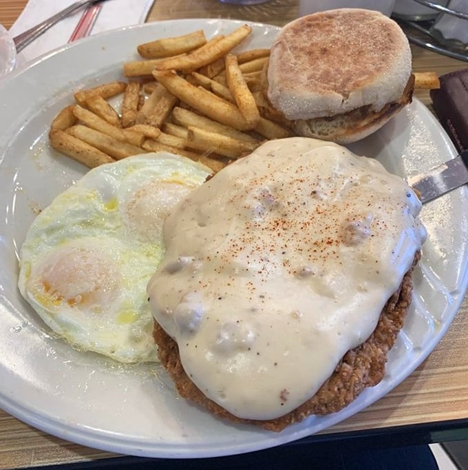 Country fried steak smothered in creamy gravy—proof that some mornings require serious sustenance and a nap scheduled for later.