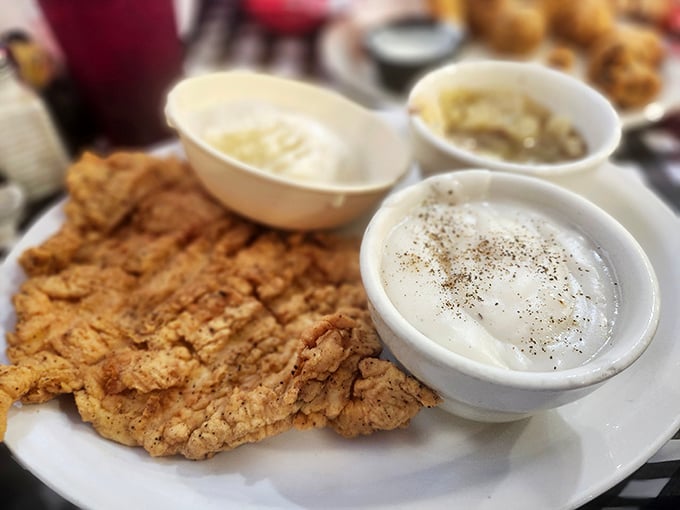Golden-battered perfection meets peppery cream gravy – this chicken fried steak isn't just a meal, it's a religious experience for Texans.