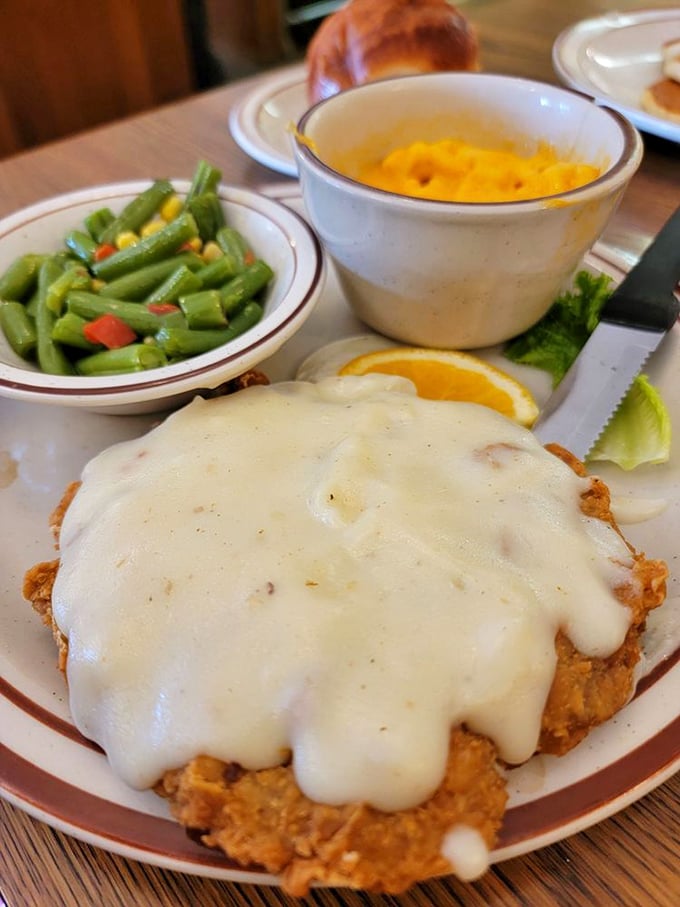 Behold the star attraction: chicken fried steak smothered in gravy so good you'll want to write poetry about it. Comfort food nirvana achieved.
