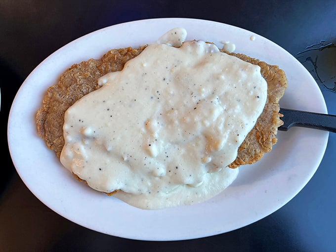 Behold the holy grail of Texas cuisine—chicken fried steak swimming in pepper-flecked gravy that your grandma would approve of.