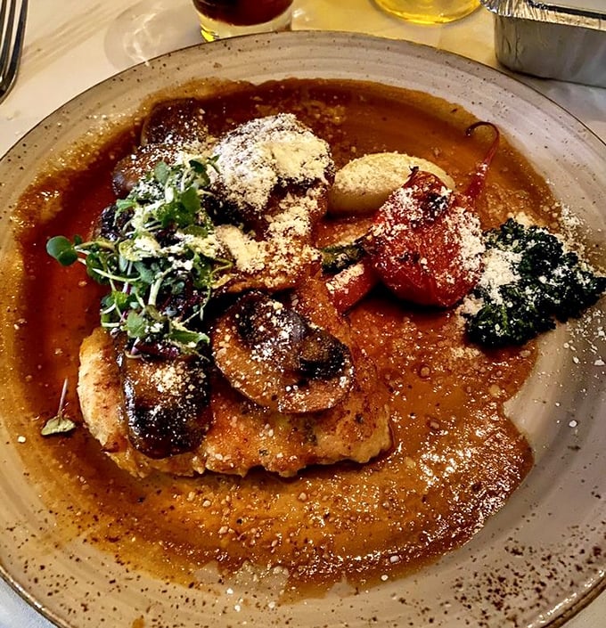 The legendary Chicken Marsala arrives like a work of art—golden chicken bathed in that mahogany sauce with mushrooms playing hide and seek throughout.