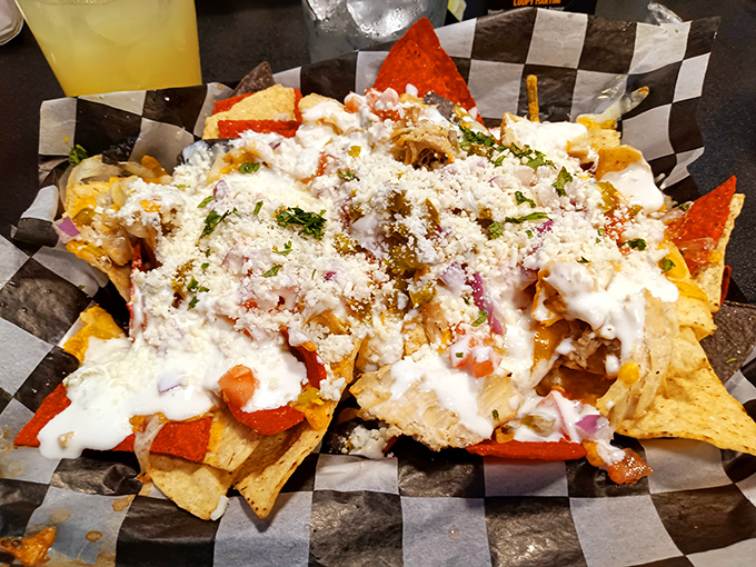Behold the chicken nachos in all their glory—crispy chips buried under toppings that would make your cardiologist nervous and your taste buds ecstatic.