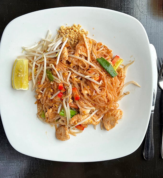 Behold the star of the show—Chicken Pad Thai that's achieved celebrity status in Alexandria. That lime wedge isn't just garnish, it's the final puzzle piece.
