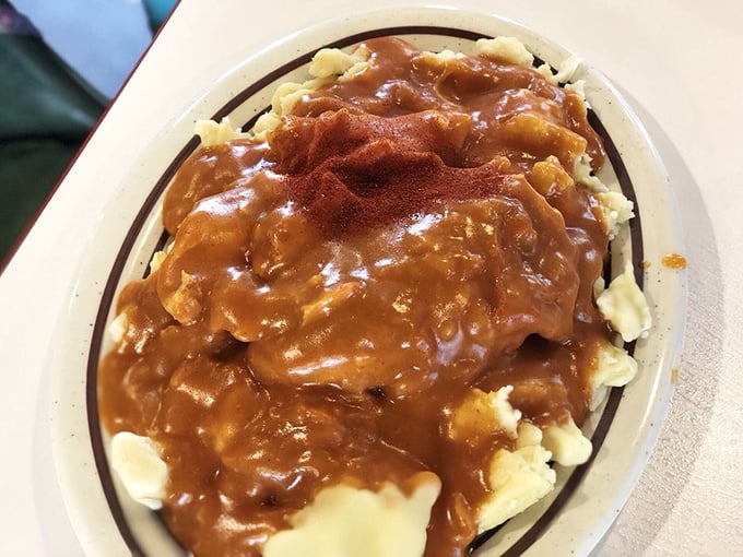 This isn't just gravy—it's a paprika-kissed masterpiece cascading over dumplings that have been soaking up delicious secrets for generations.