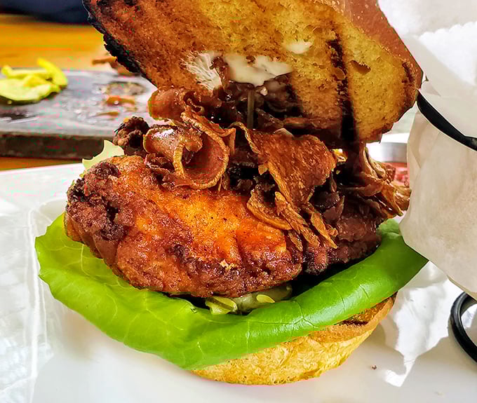 Behold the infamous chicken sandwich—crispy, juicy, and stacked with toppings that make your standard fast food version look like it needs therapy.