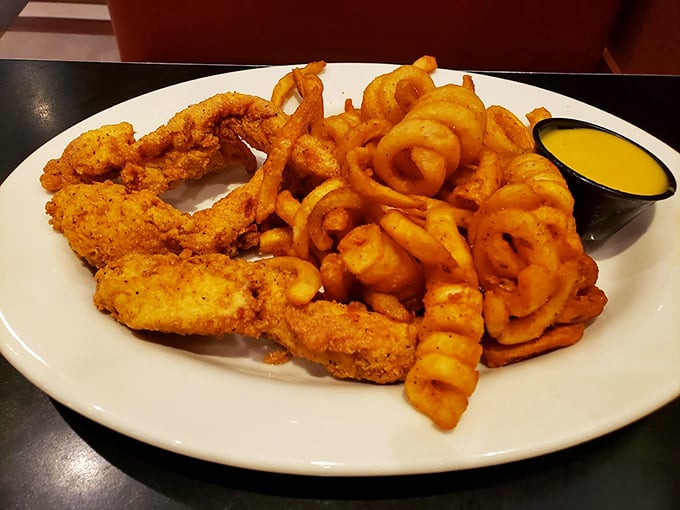 Behold the stars of our show: golden-brown chicken tenders with curly fries and that signature honey mustard. Diet plans, consider yourselves postponed.