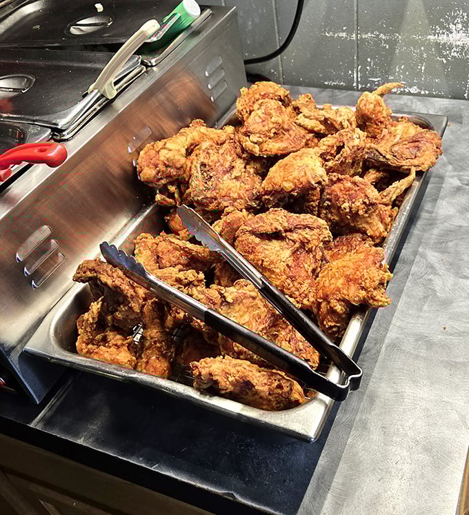 Golden-brown perfection awaits in this tray of freshly fried chicken, each piece promising a symphony of crunch and juicy tenderness.