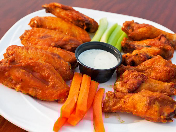 These wings aren't just cooked—they're transformed. Crispy outside, juicy inside, with celery and carrots standing by like loyal sidekicks to a superhero.
