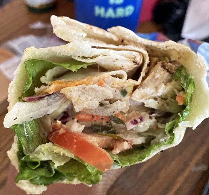 This chicken wrap isn't just lunch—it's architectural brilliance. Fresh ingredients stacked with the precision of a Jenga master who really knows their stuff.