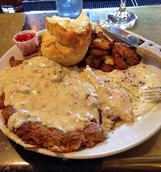 Behold: the legendary chicken fried steak in all its glory. That gravy doesn't merely cover—it embraces, like a warm hug from your favorite aunt.