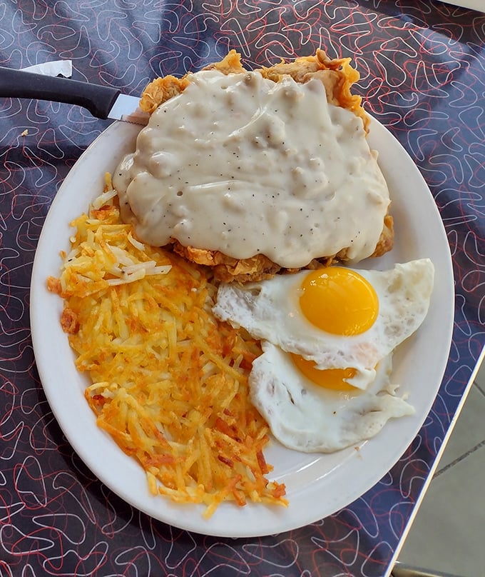 This isn't just breakfast—it's edible architecture. Golden hash browns, perfectly fried eggs, and chicken fried steak smothered in gravy that would make your grandma jealous.